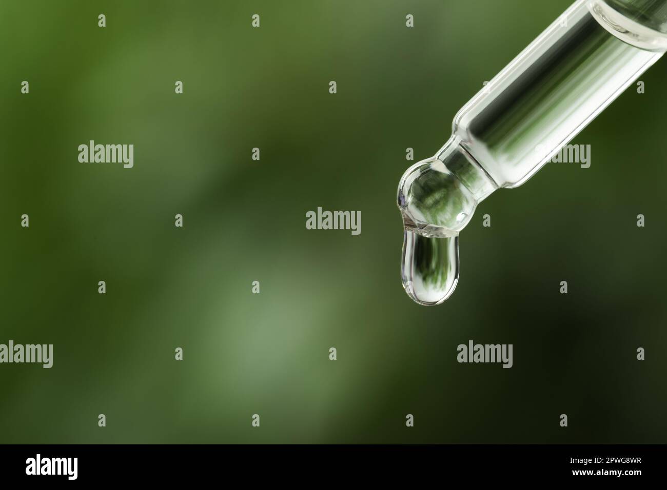 Dripping medical product from pipette against blurred background ...