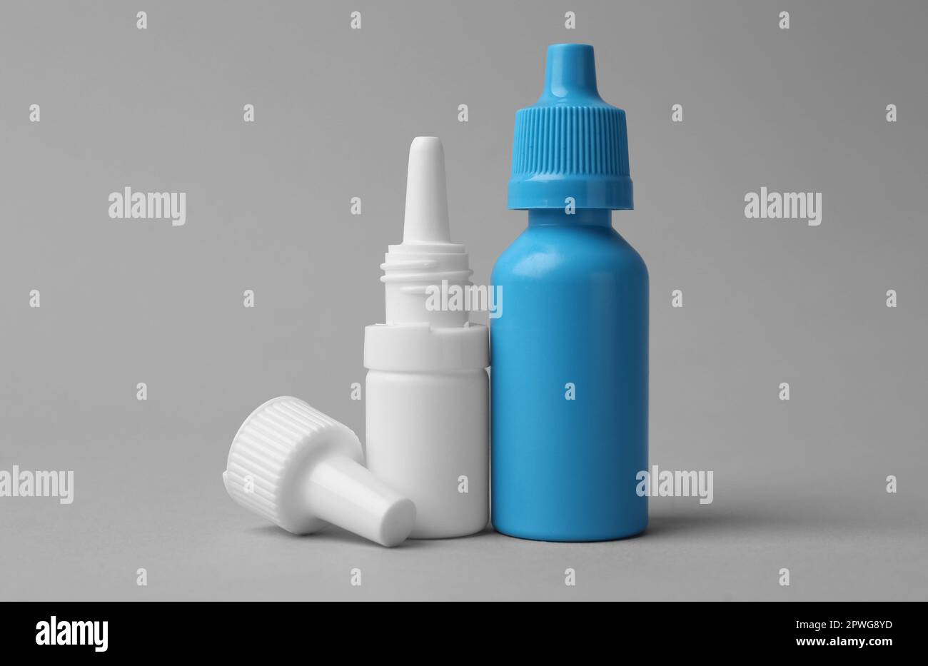 Bottles of medical drops on grey background Stock Photo - Alamy