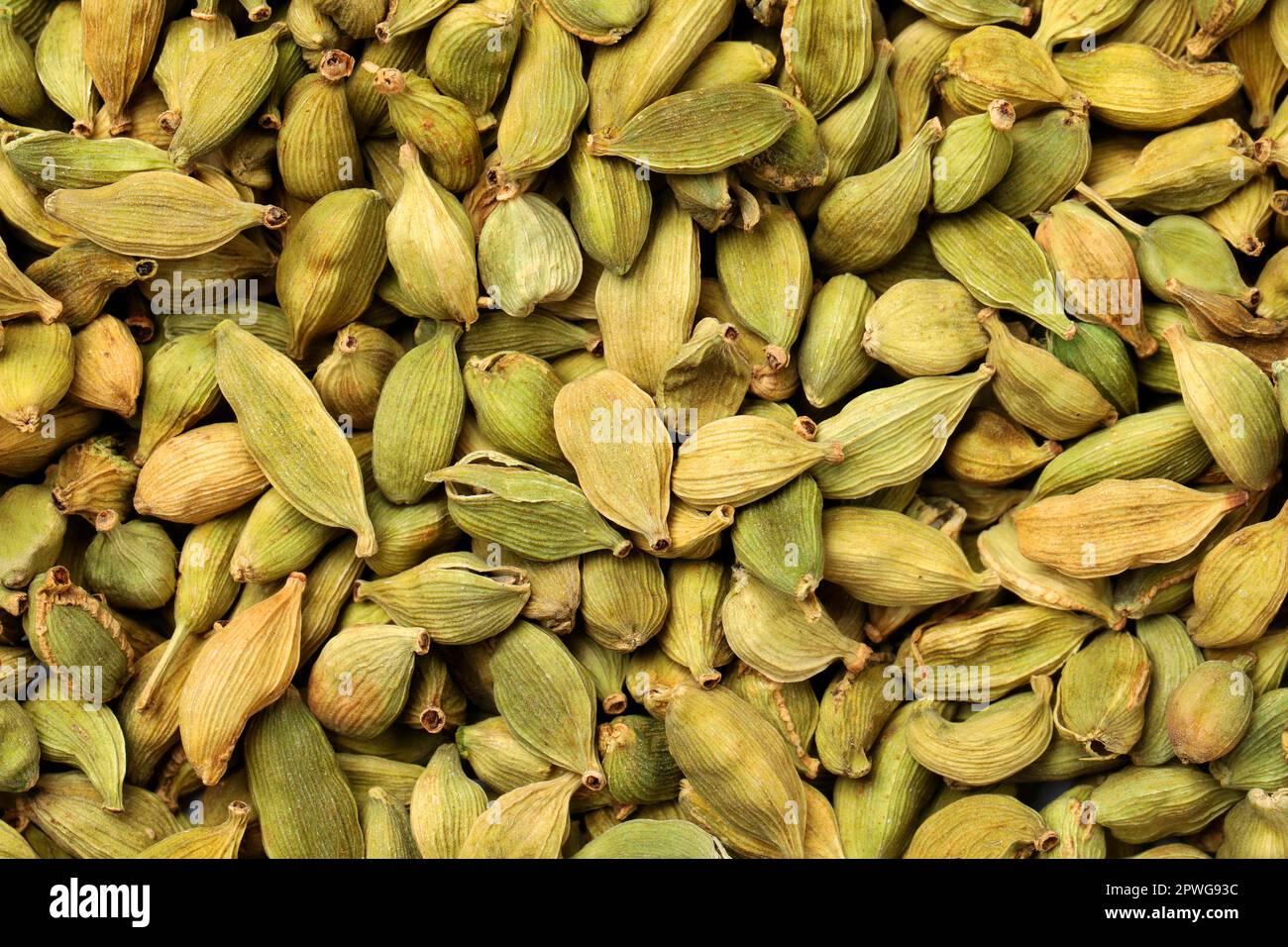 Pile of dry green cardamom pods as background, top view Stock Photo - Alamy
