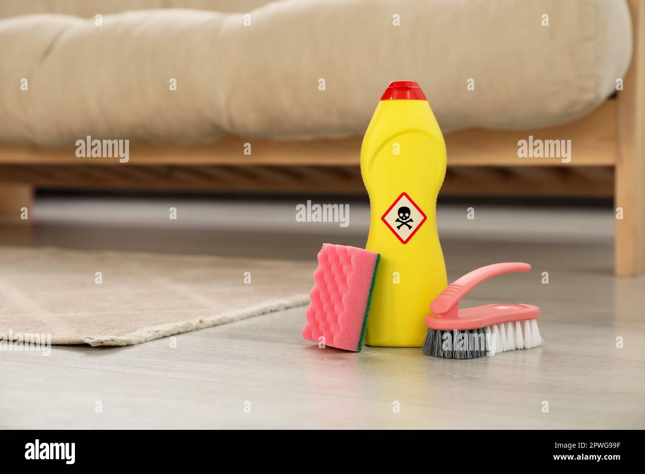Bottle of toxic household chemical with warning sign, brush and ...