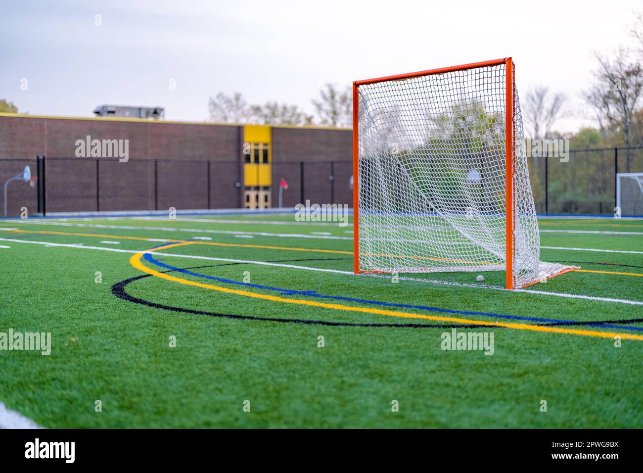 Late afternoon photo of a lacrosse goal on a synthetic turf field ...