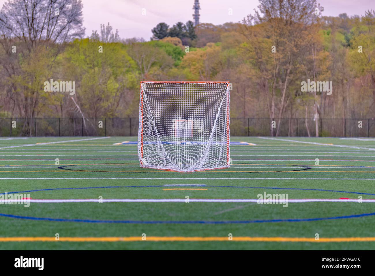 Late afternoon photo of a lacrosse goal on a synthetic turf field ...