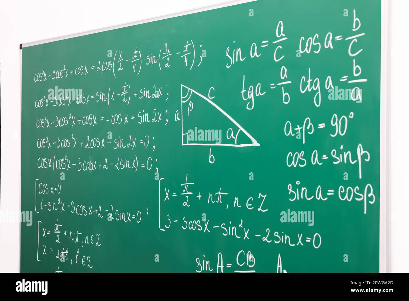 Many different math formulas written on green chalkboard Stock Photo - Alamy