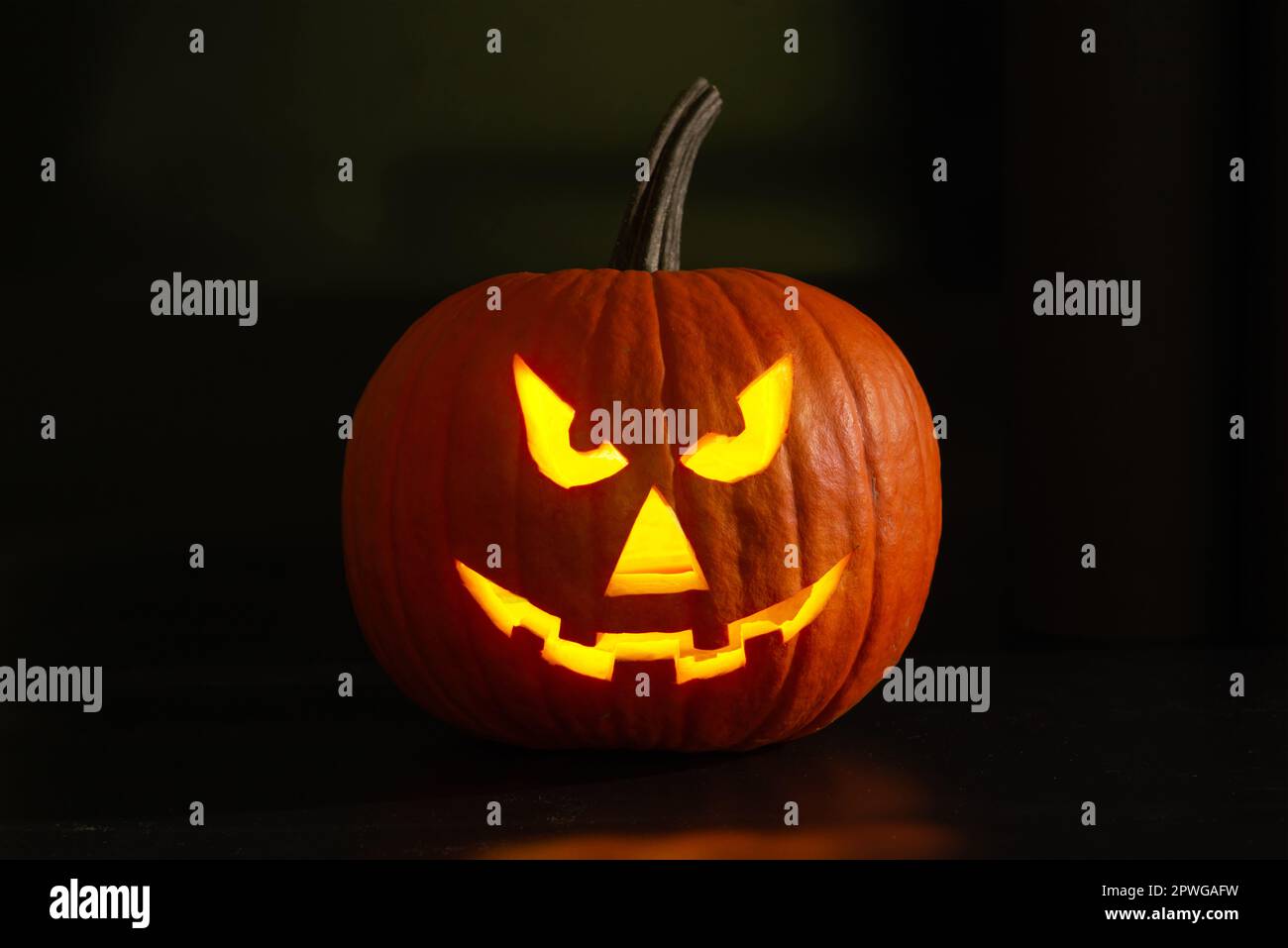Scary jack o'lantern pumpkin in darkness. Halloween decor Stock Photo ...