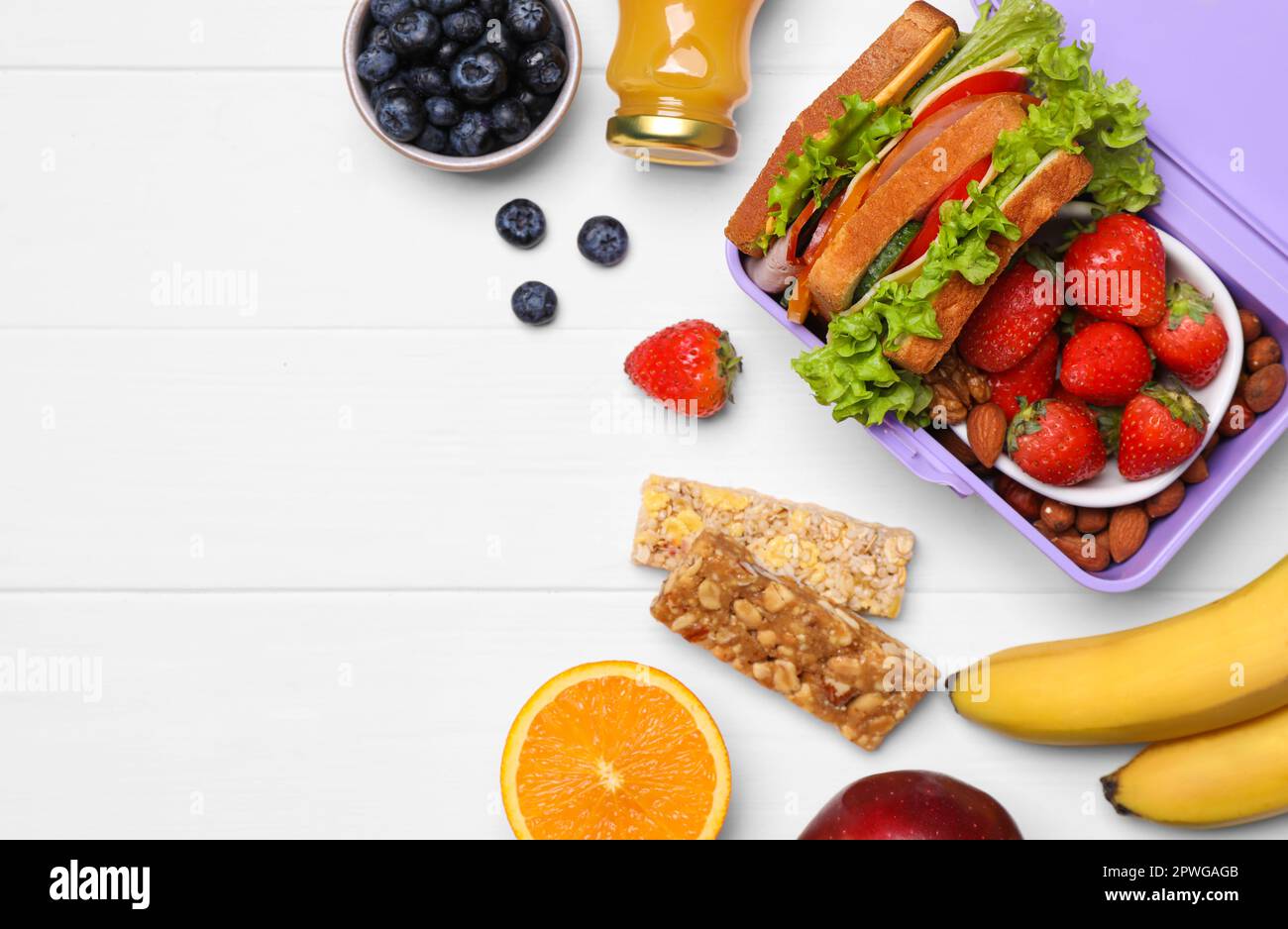 Lunch box with healthy food on white wooden table, flat lay. Space for ...