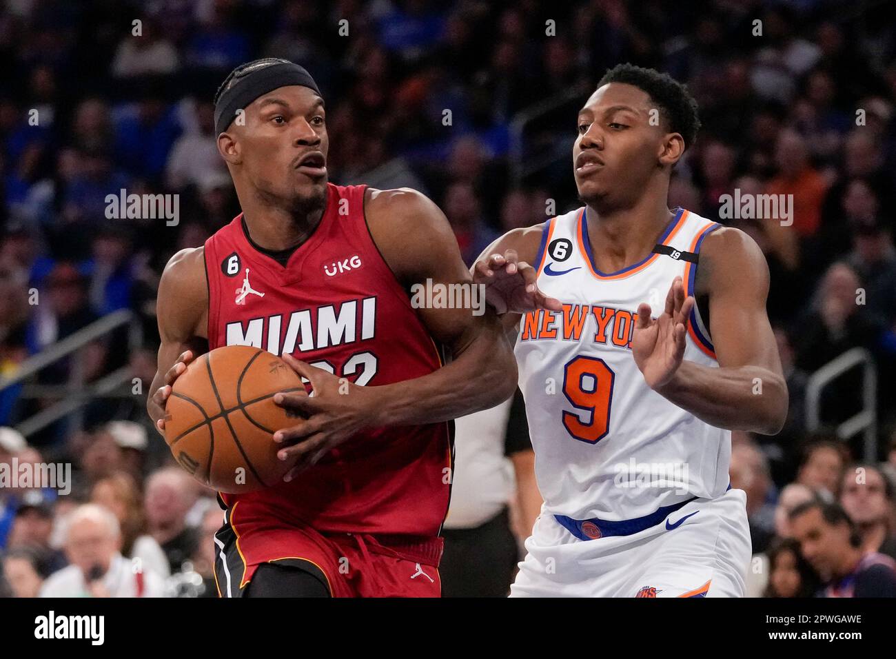Miami Heat forward Jimmy Butler (22) drives against New York Knicks guard RJ Barrett (9) during ...
