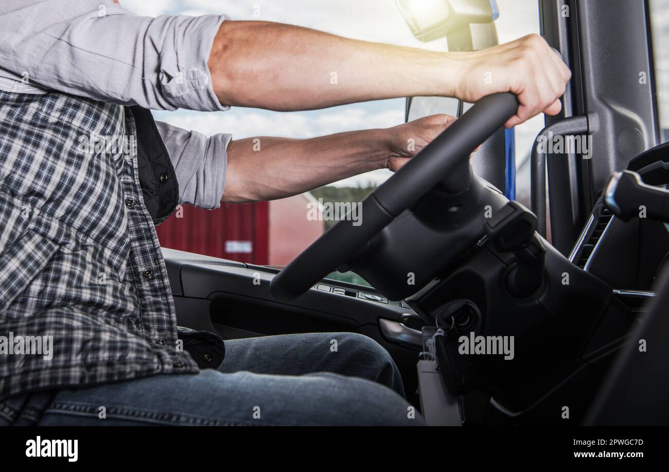 Professional Semi Truck Driver Behind the Tractor Wheel. Heavy ...