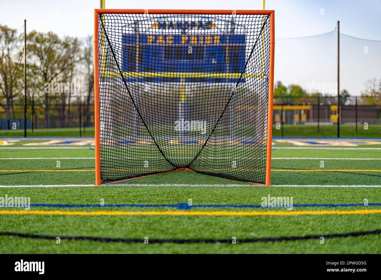 Late afternoon photo of a lacrosse goal on a synthetic turf field ...