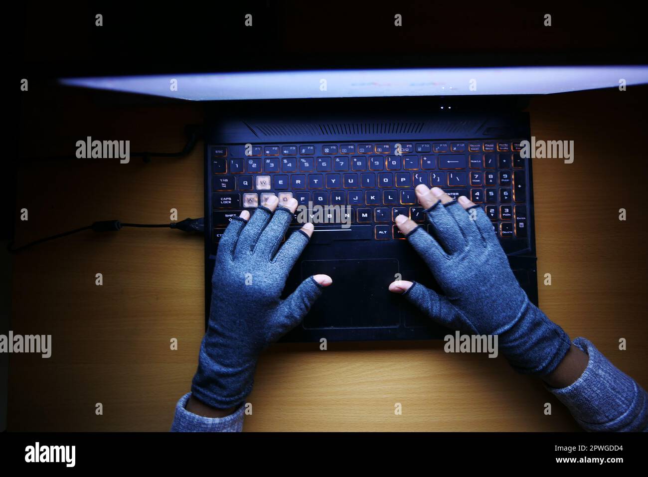 hacker hand stealing data from laptop top down Stock Photo - Alamy