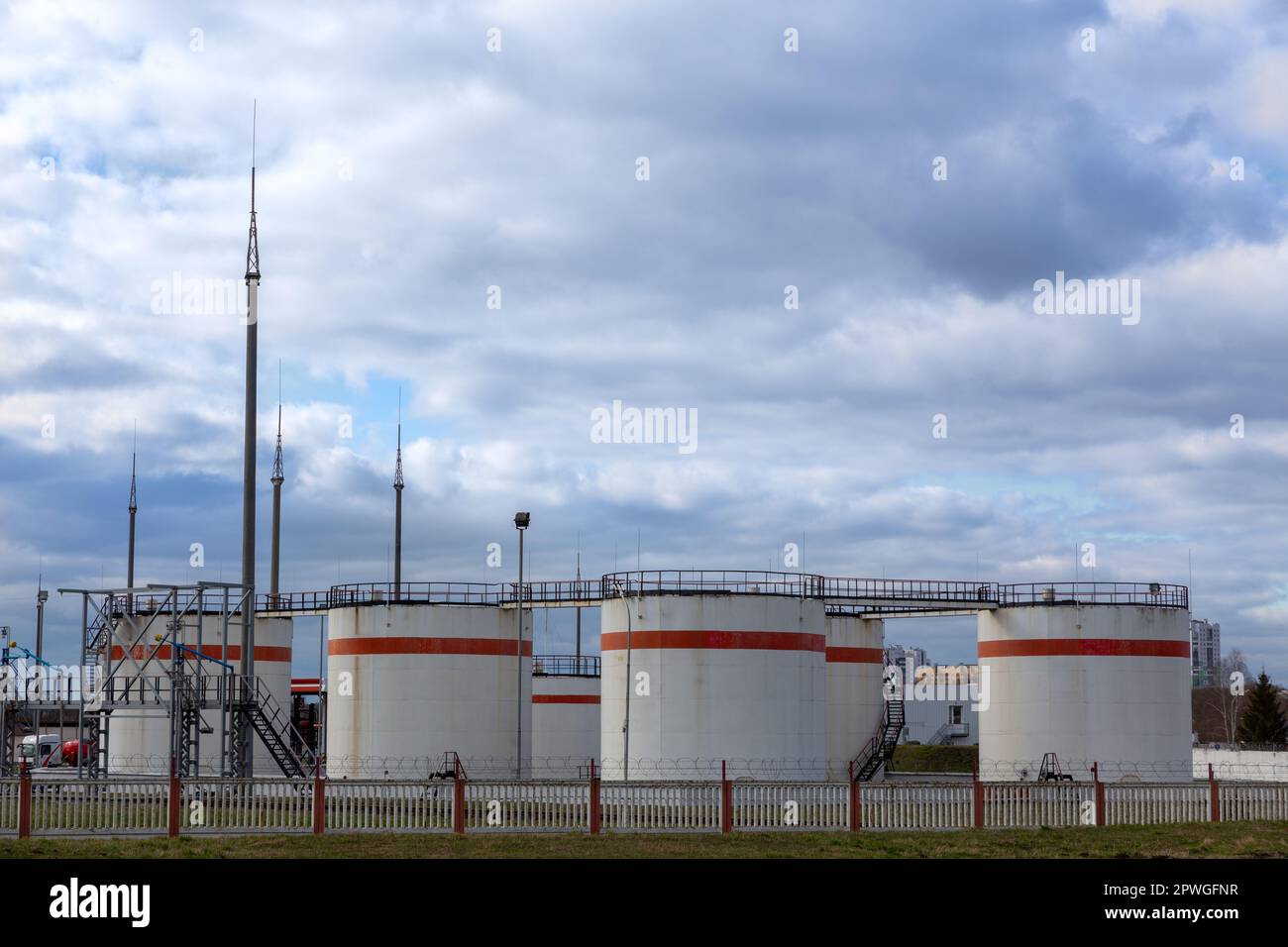 Tank farm with cylindrical fuel storage, fenced, with lightning rods ...