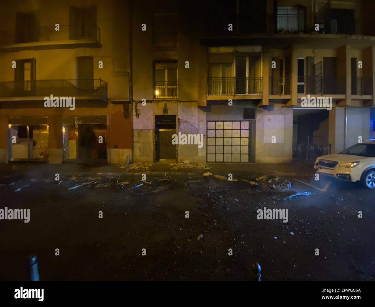 Smoke on the street on a night urban scene with riots and fires and ...