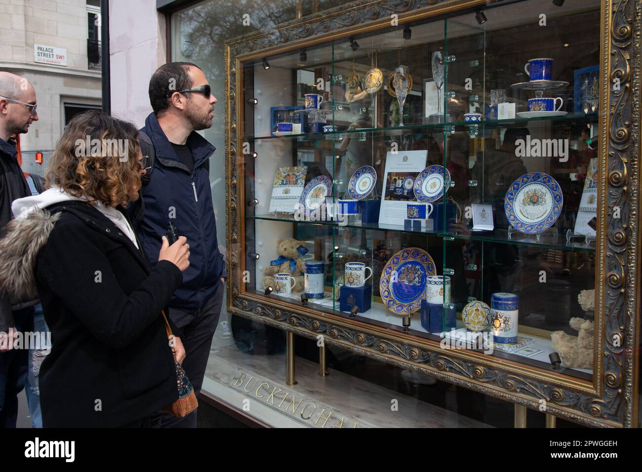 London, UK. 30th Apr 2023. Customers stop in front of a shop window ...