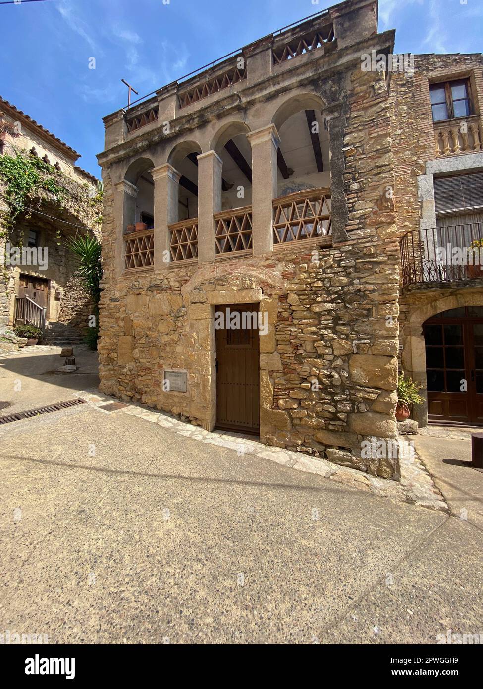 Ancient restored building facade with arch terrace in a Mediterranean ...