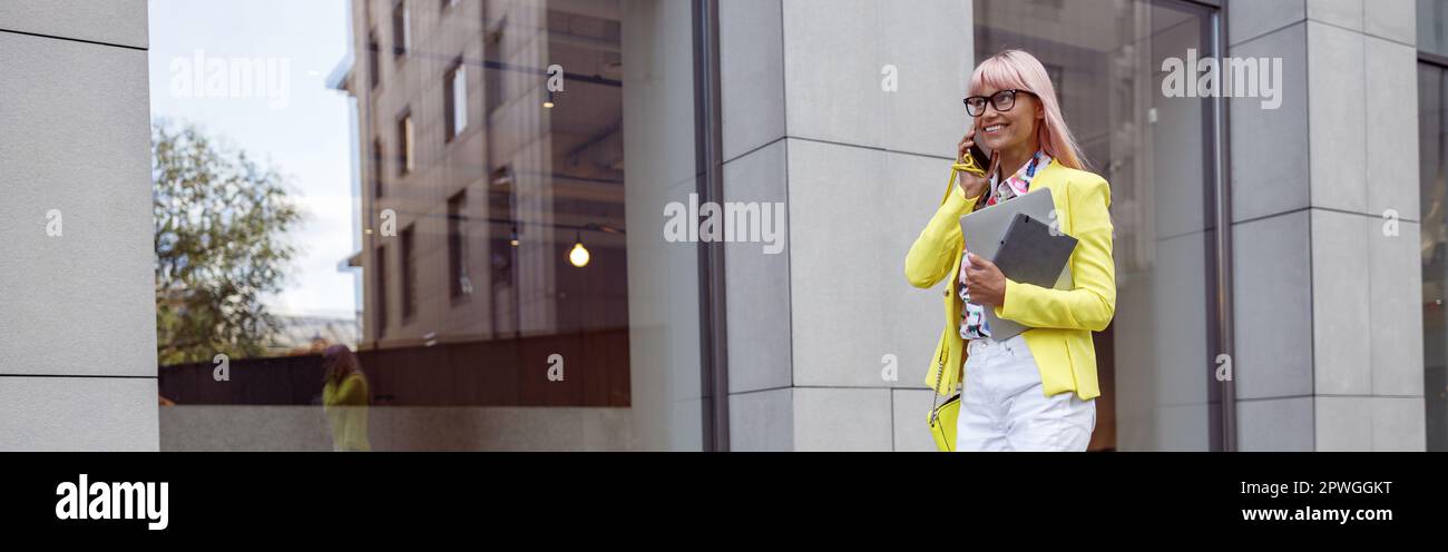 Pleased pedestrian having phone discussion while walking on pavement ...