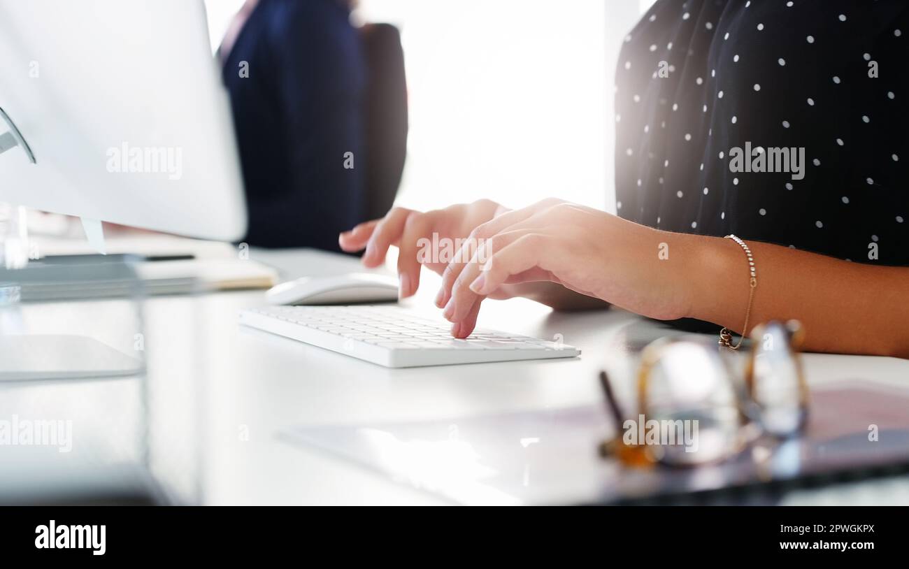 Productivity flies through her fingertips. businesswoman using a ...
