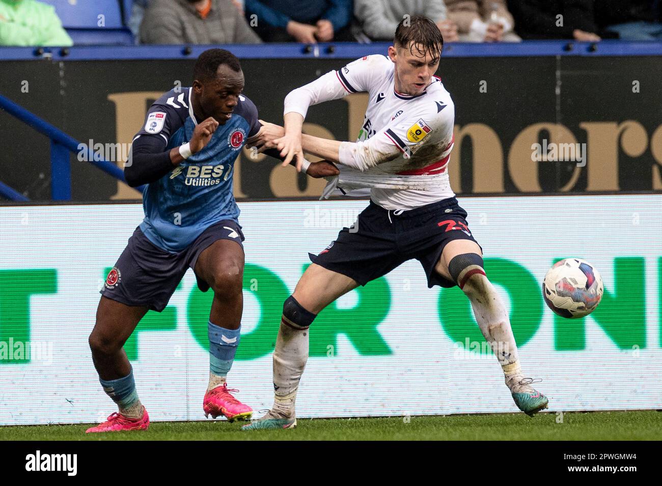 George Thomason #25 of Bolton Wanderers tackled by Carlos Mendes Gomes ...