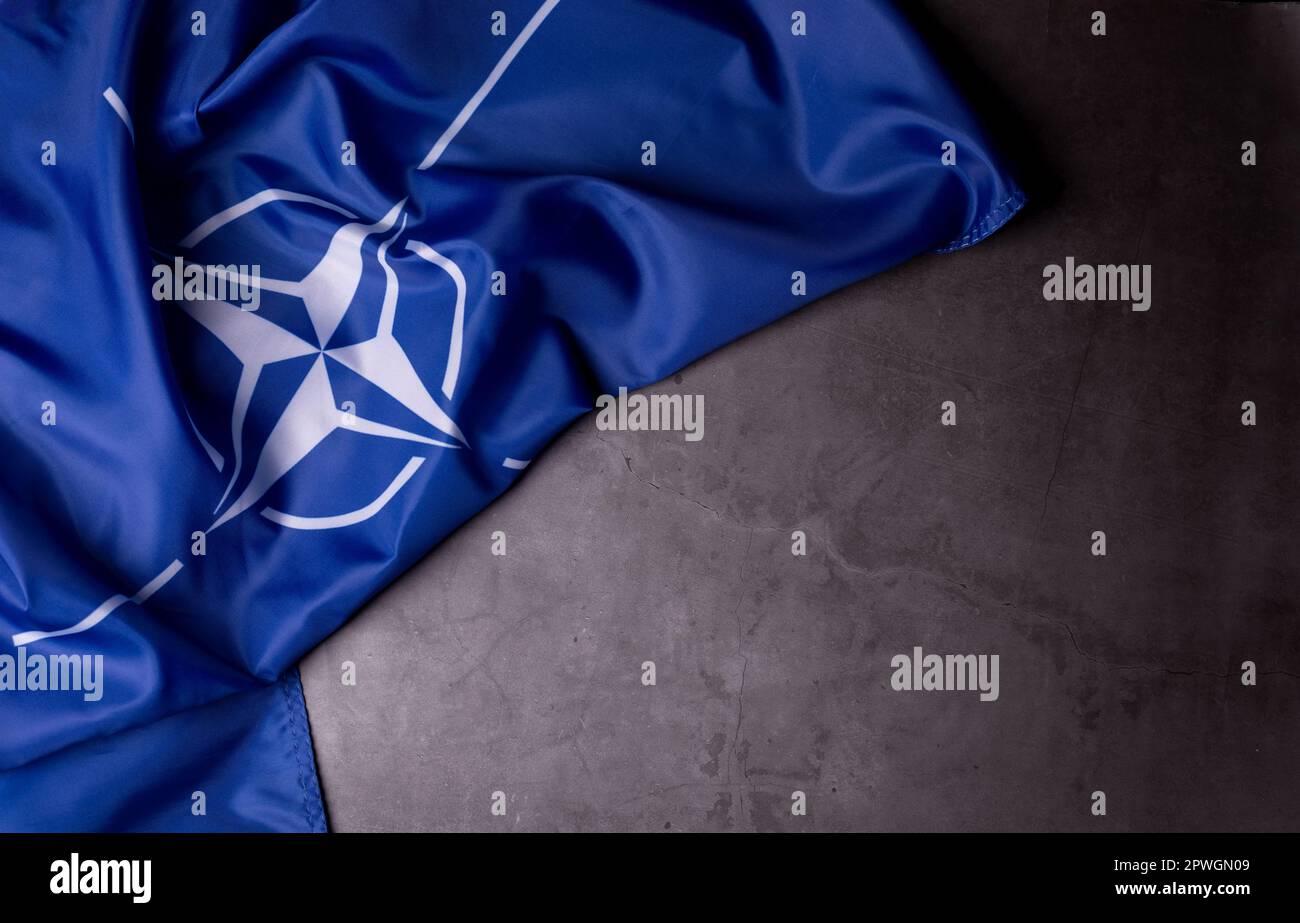 Ukraine, Kyiv - 10.04.2023. Official Flag of NATO against gray ...