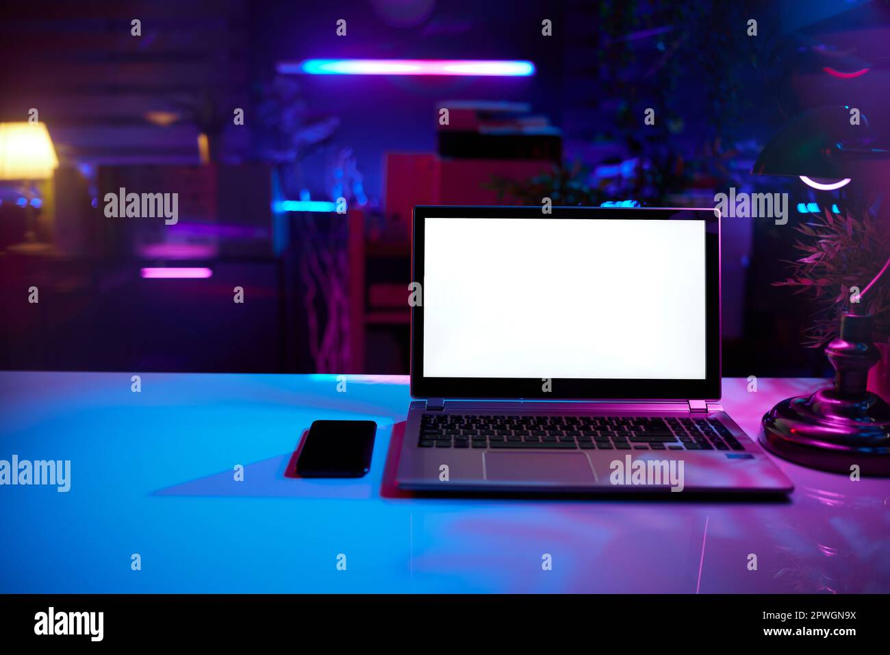 Neon metaverse futuristic concept. modern office with desk and laptop ...