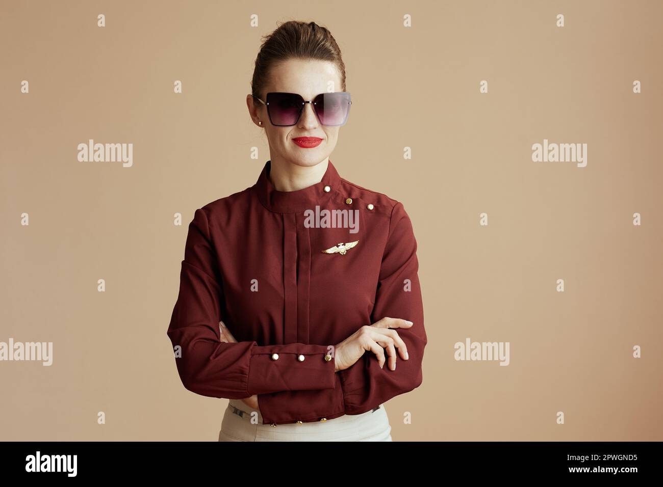 stylish air hostess woman on beige background with sunglasses Stock ...