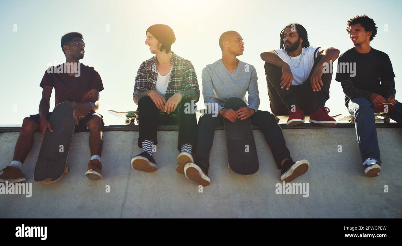 Friends skate together through anything. Full length shot of a group of ...