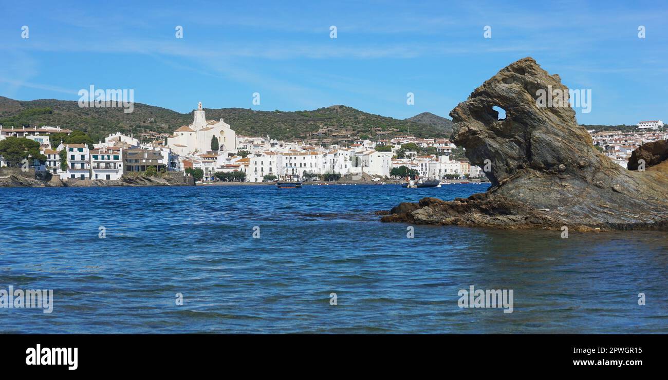 Coastal Mediterranean village in Spain with a natural rock formation in ...