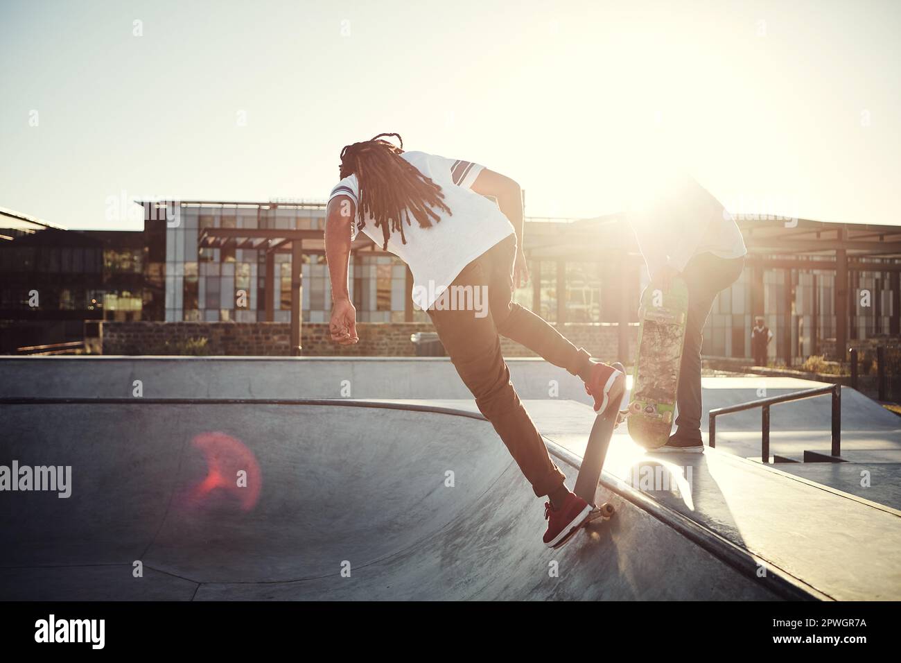 Perfect technique. Full length shot of two young men skating together ...