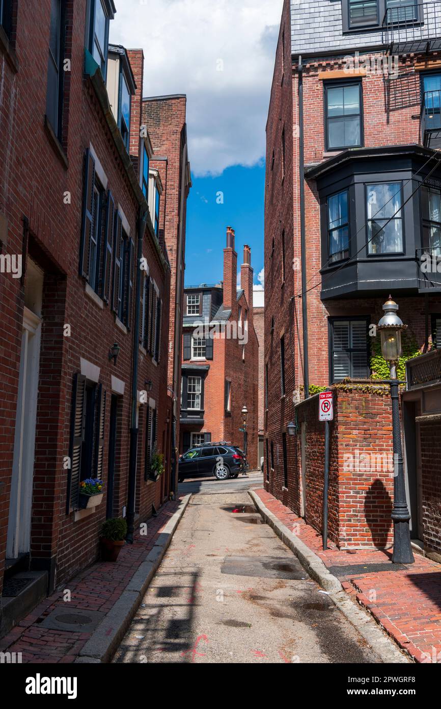 Red brick houses with chimneys, brick paved sidewalks at narrow streets ...