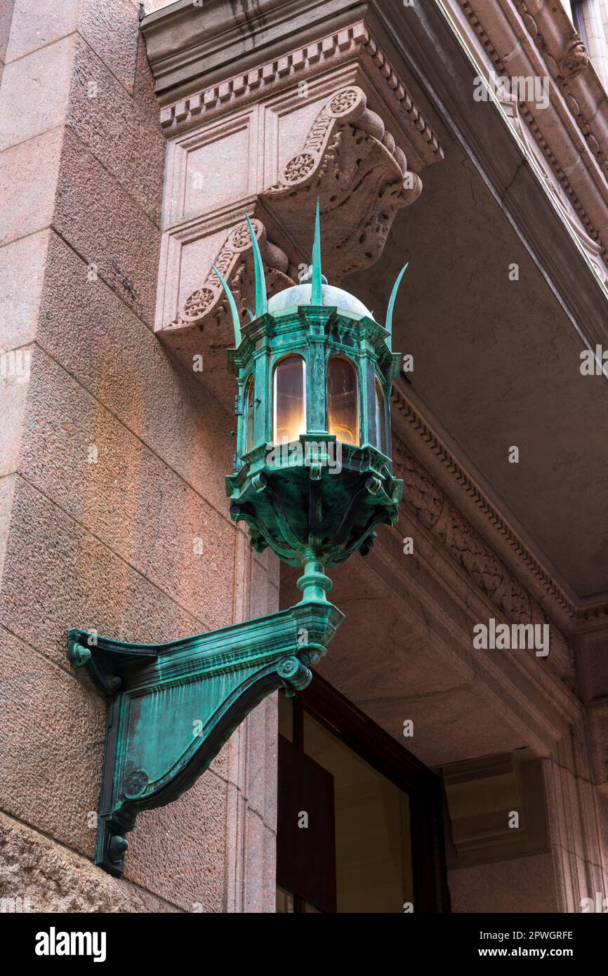 Rustic oxidized brass streetlight mounted on a building wall at Kilby ...
