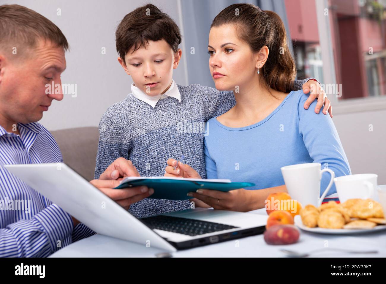 Mother with son consulting with insurance agent Stock Photo - Alamy