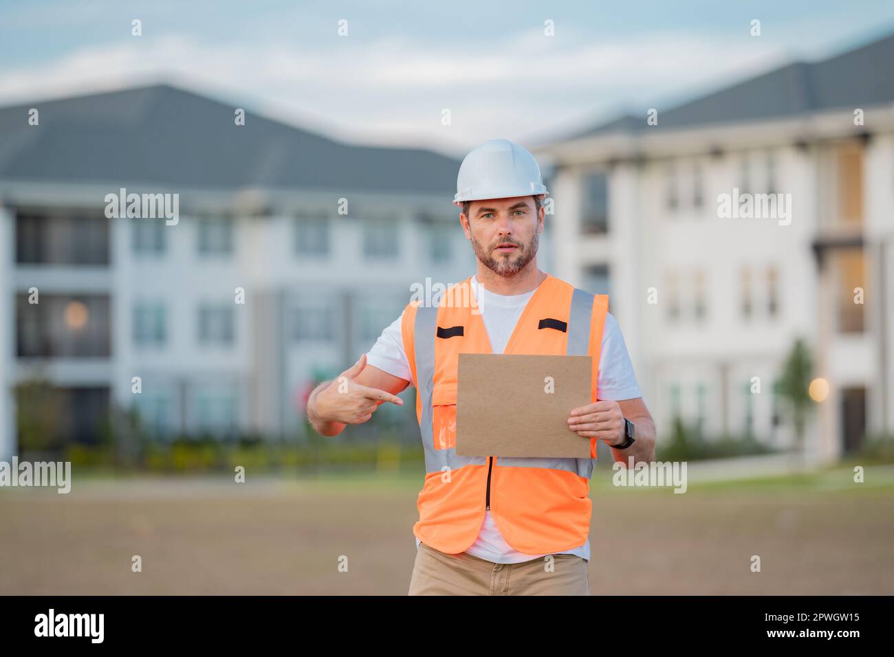 Engineer hold paper board for text. Builder showing signboard placard ...