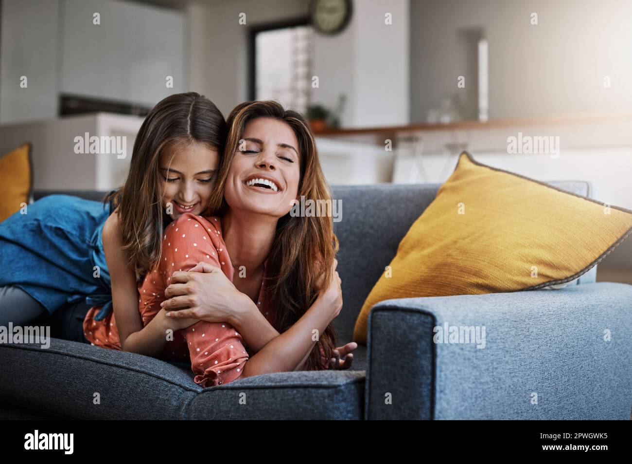 This is the best. an attractive young woman and her daughter hugging while spending time ...