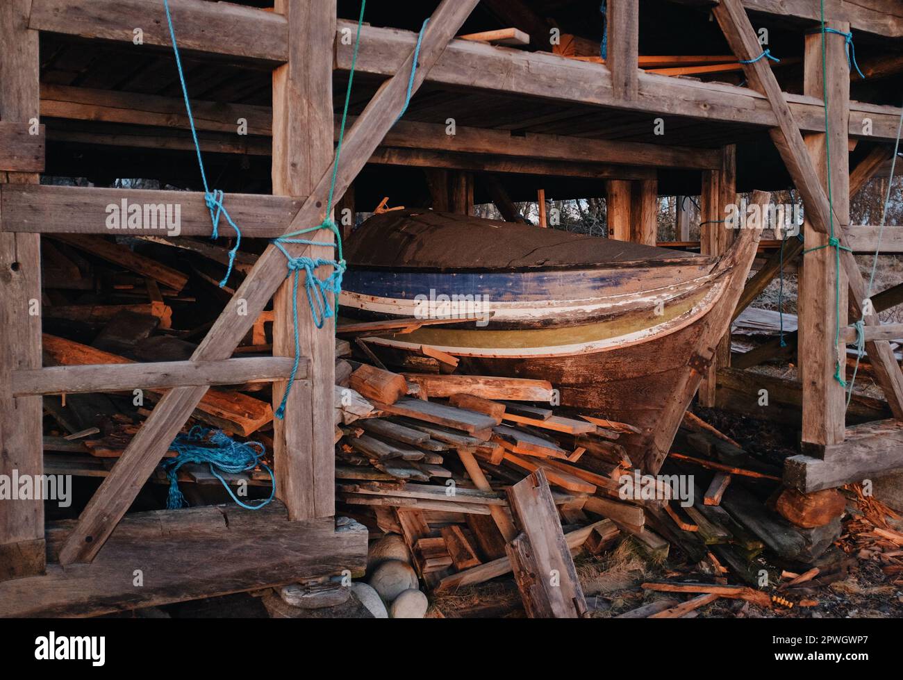 old wooden row boat in a abandoned shack Stock Photo - Alamy