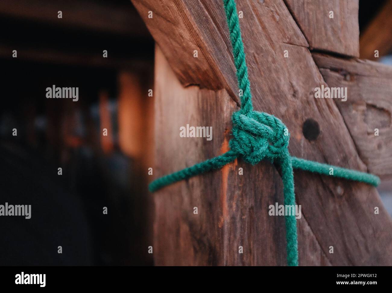 detail of a knot on a green rope tied around wooden timber Stock Photo ...