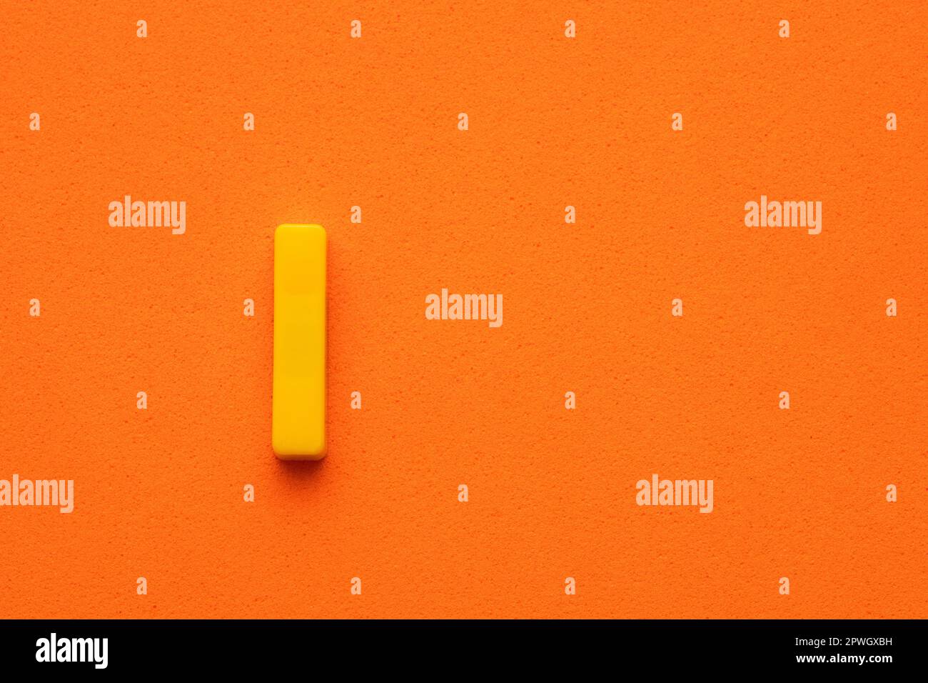 Yellow plastic letter I uppercase on orange foamy background Stock ...