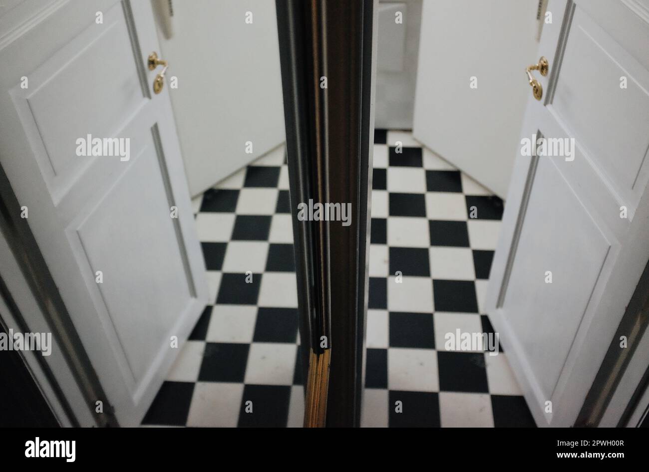 detail of a white door and checkered floor Stock Photo - Alamy