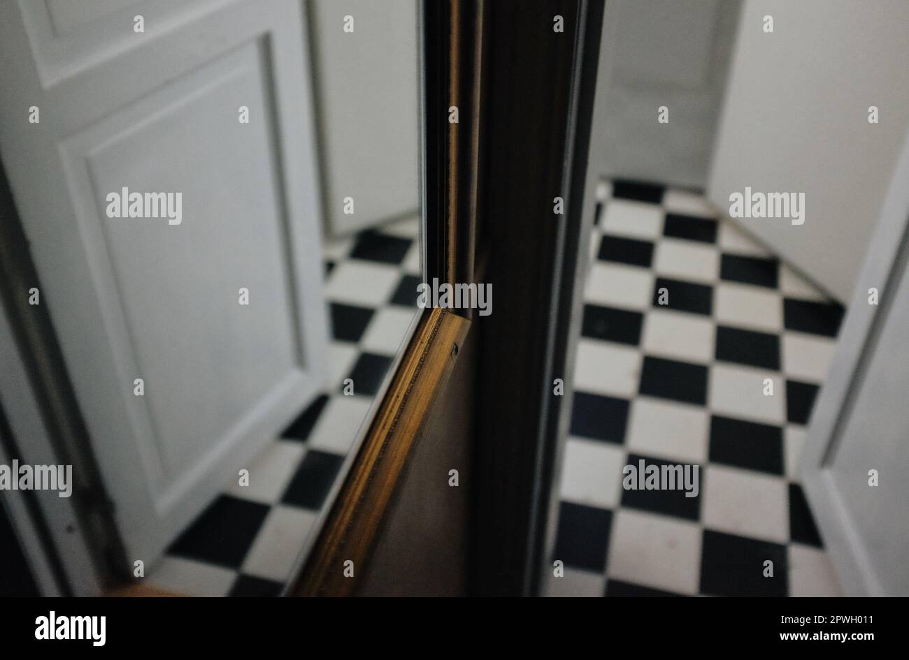 detail of a white door and checkered floor Stock Photo - Alamy
