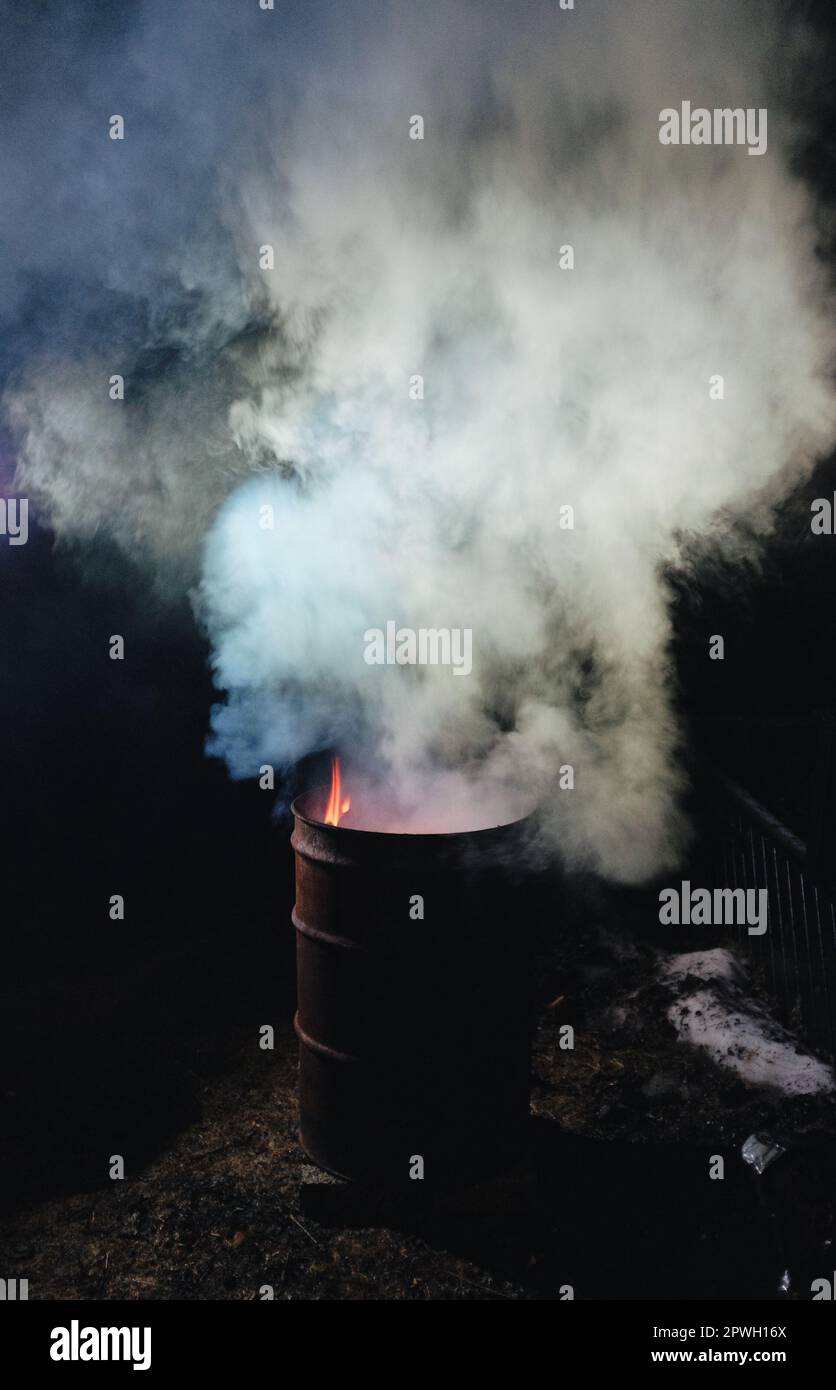 fire burning inside a metal barrel Stock Photo - Alamy