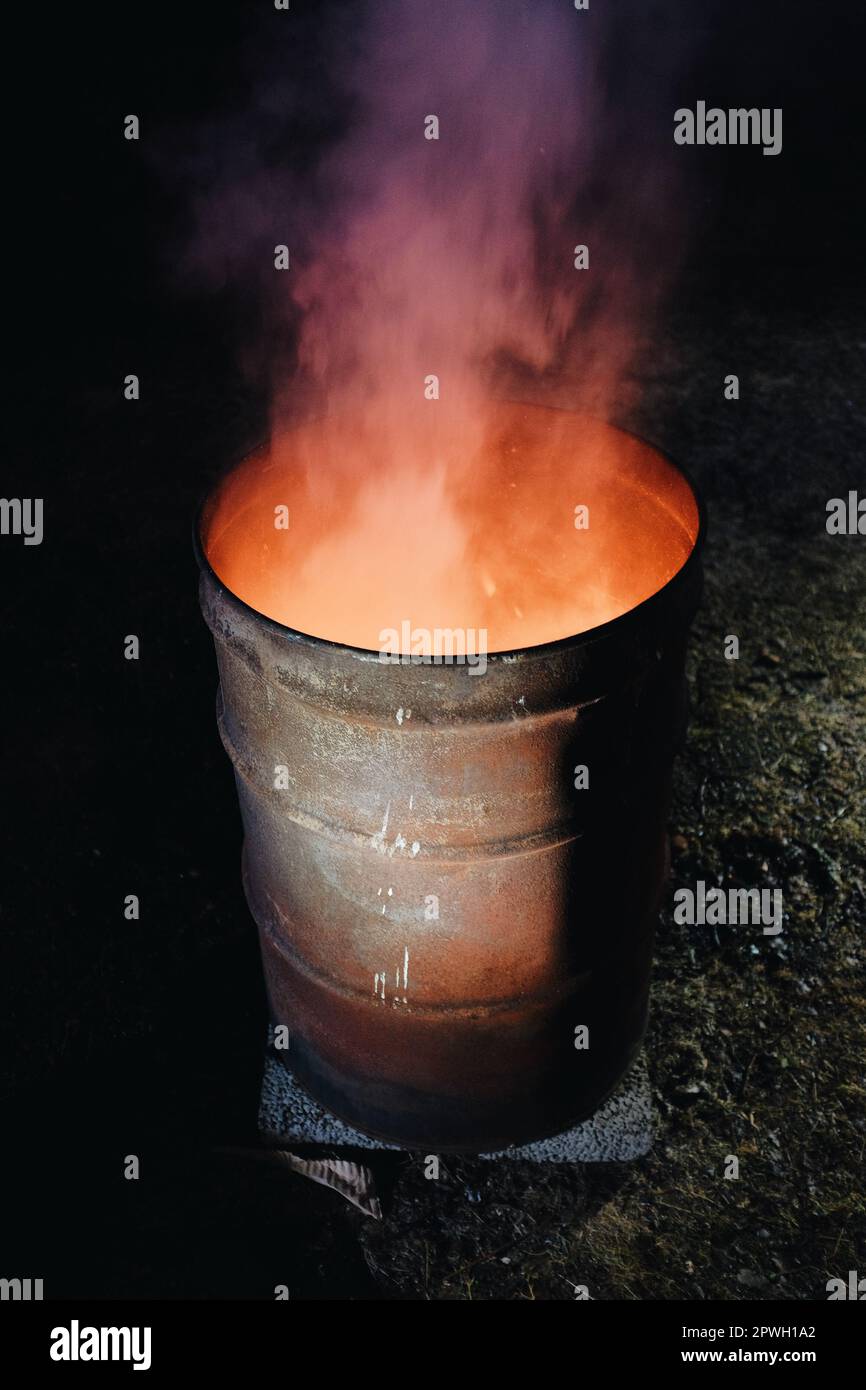 fire burning inside a metal barrel Stock Photo - Alamy