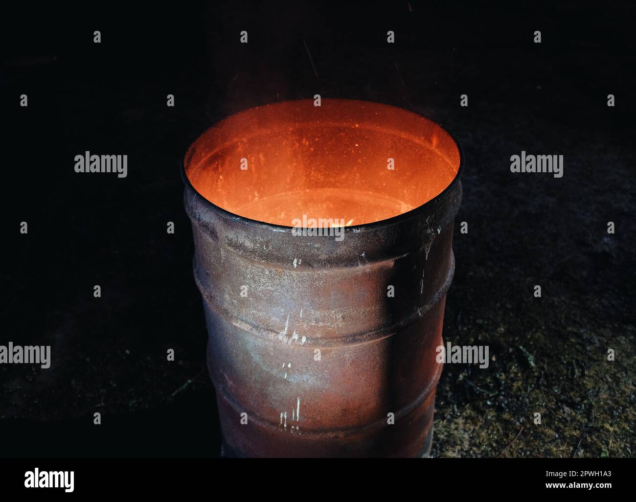 fire burning inside a metal barrel Stock Photo - Alamy