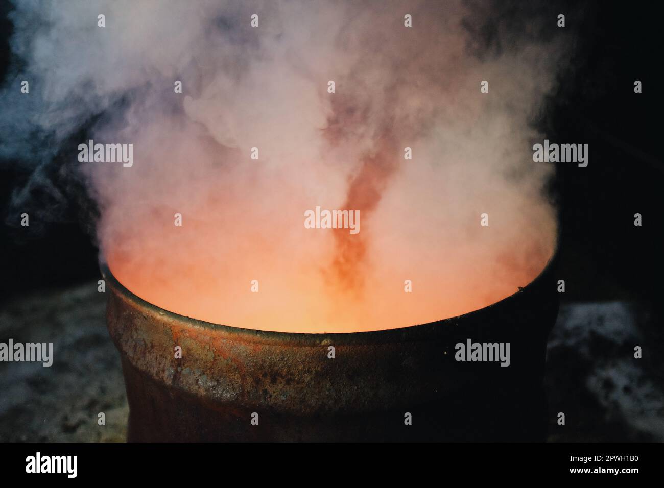 fire burning inside a metal barrel Stock Photo - Alamy