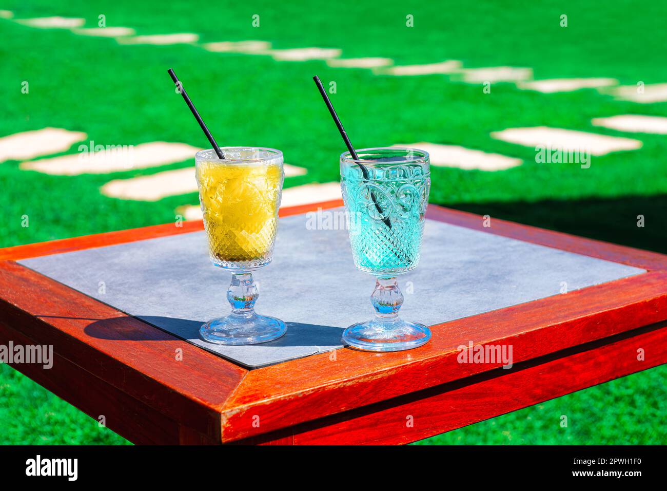 Crystal cups with cocktails on the table . Summer refreshment drink ...