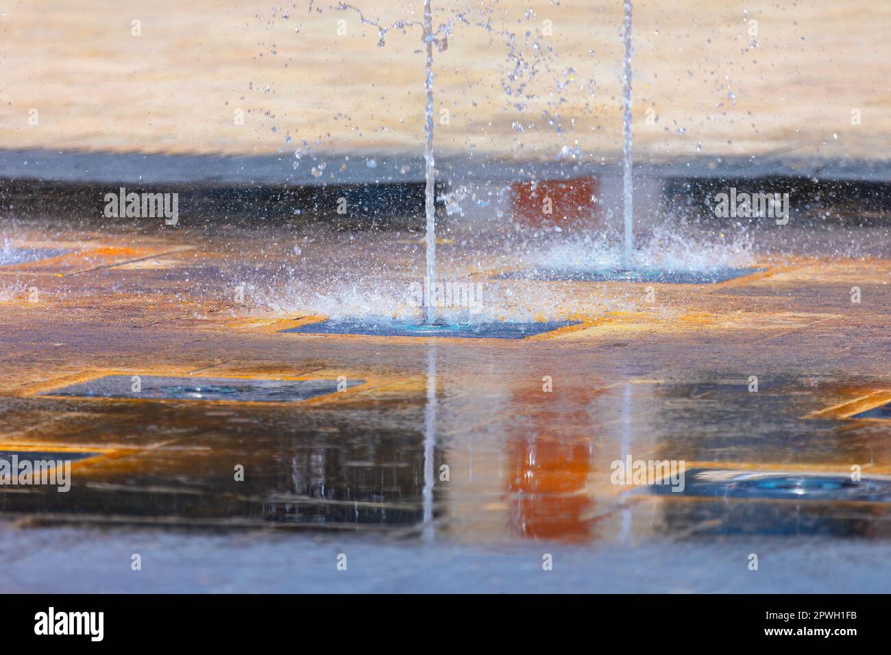 Fountain on a street pavement . Splashing water on the street Stock ...