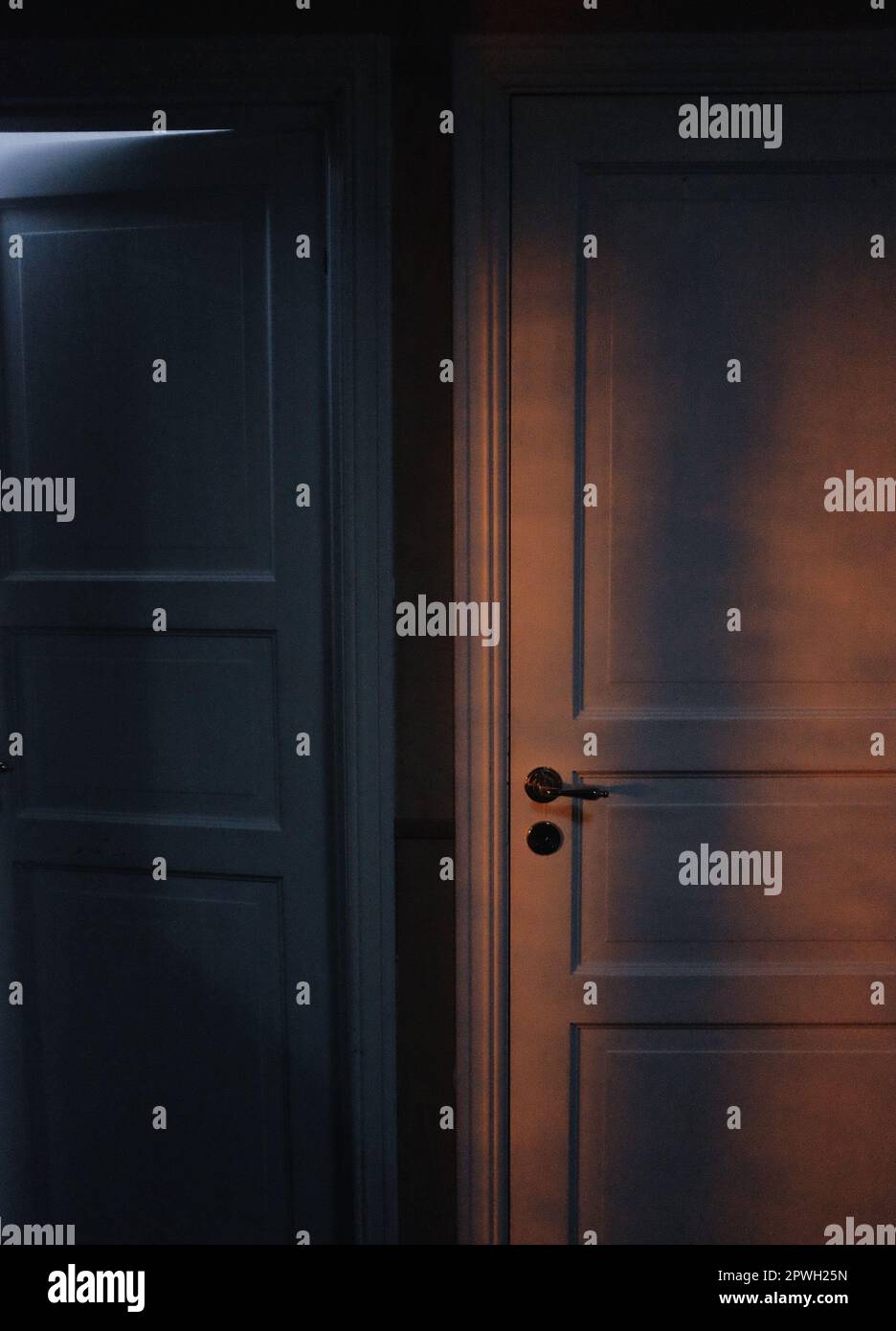 hallway, three closed doors with atmospheric light at night Stock Photo ...