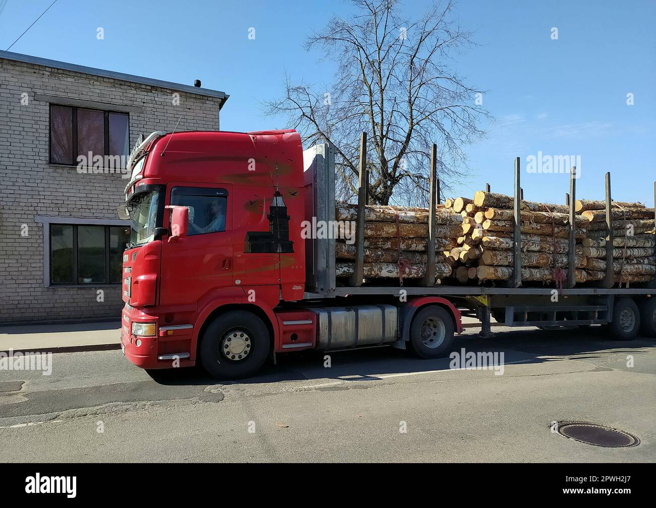 Timber transportation on Silikatu street in Riga. Timber truck with ...