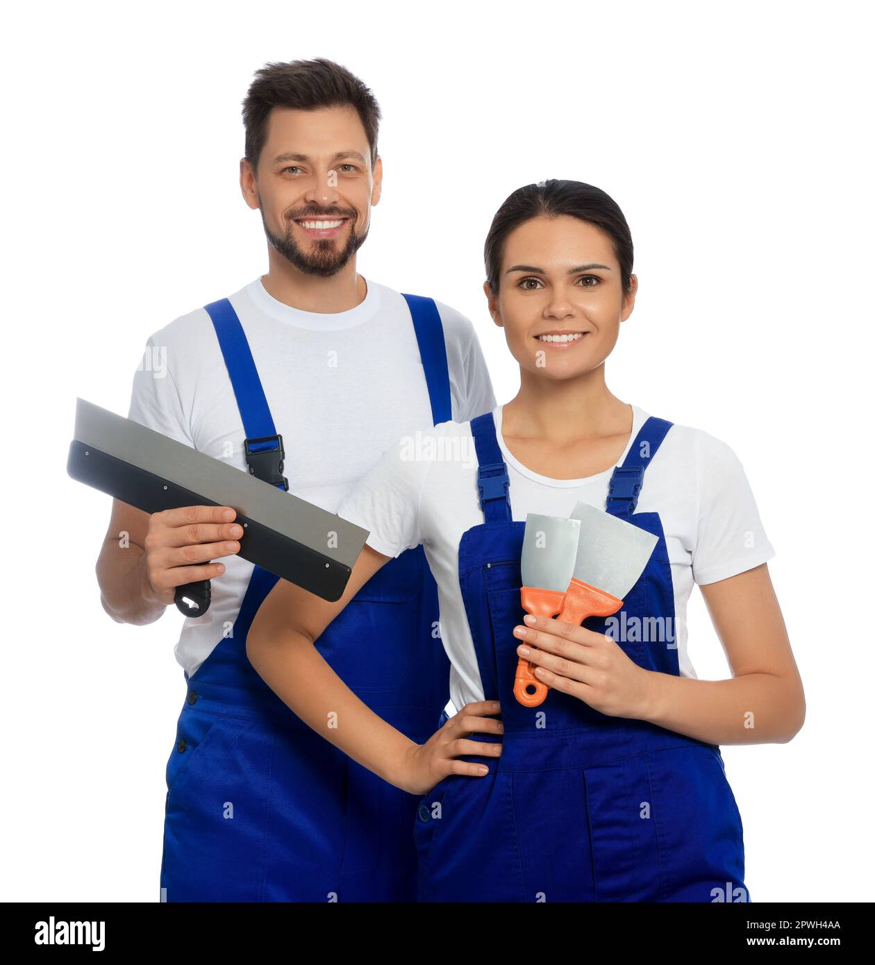 Professional workers in uniform with putty knives on white background ...