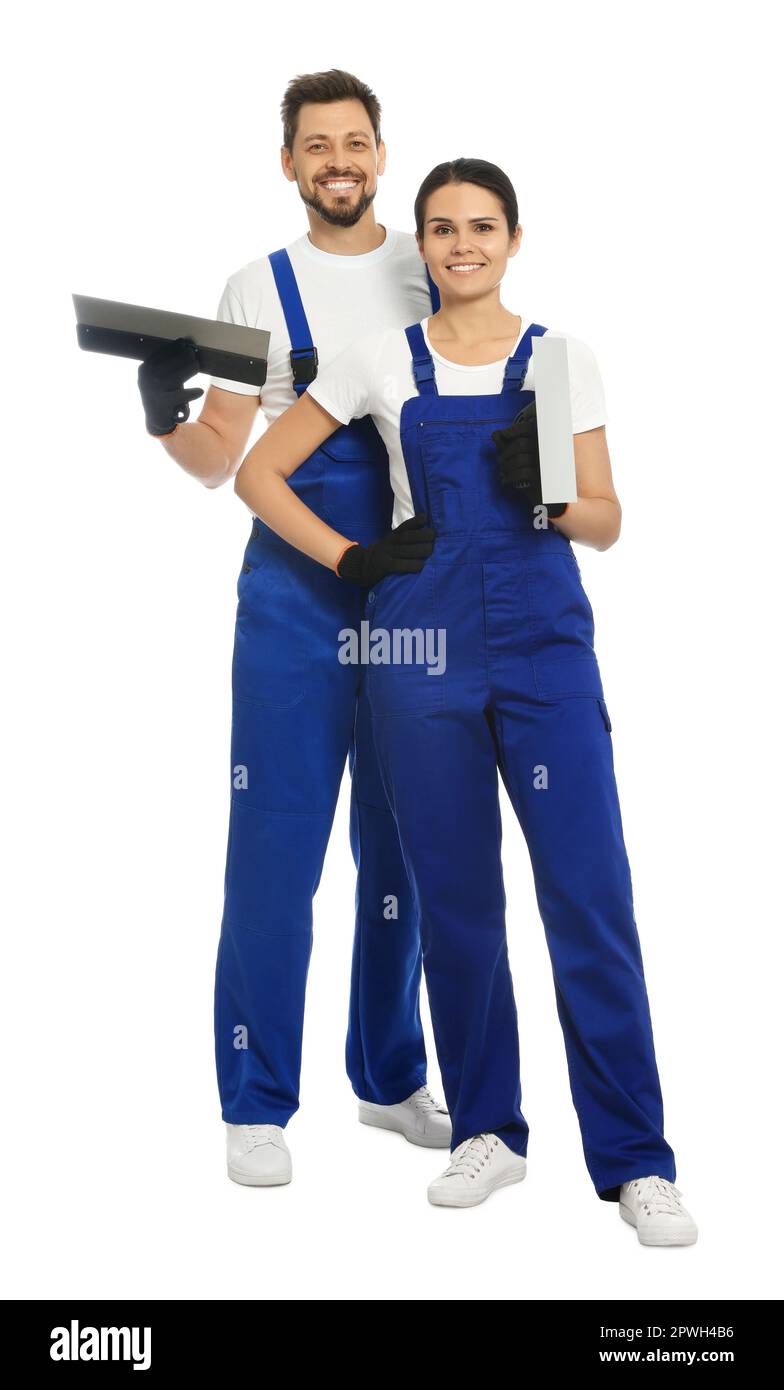 Professional workers in uniform with putty knives on white background ...