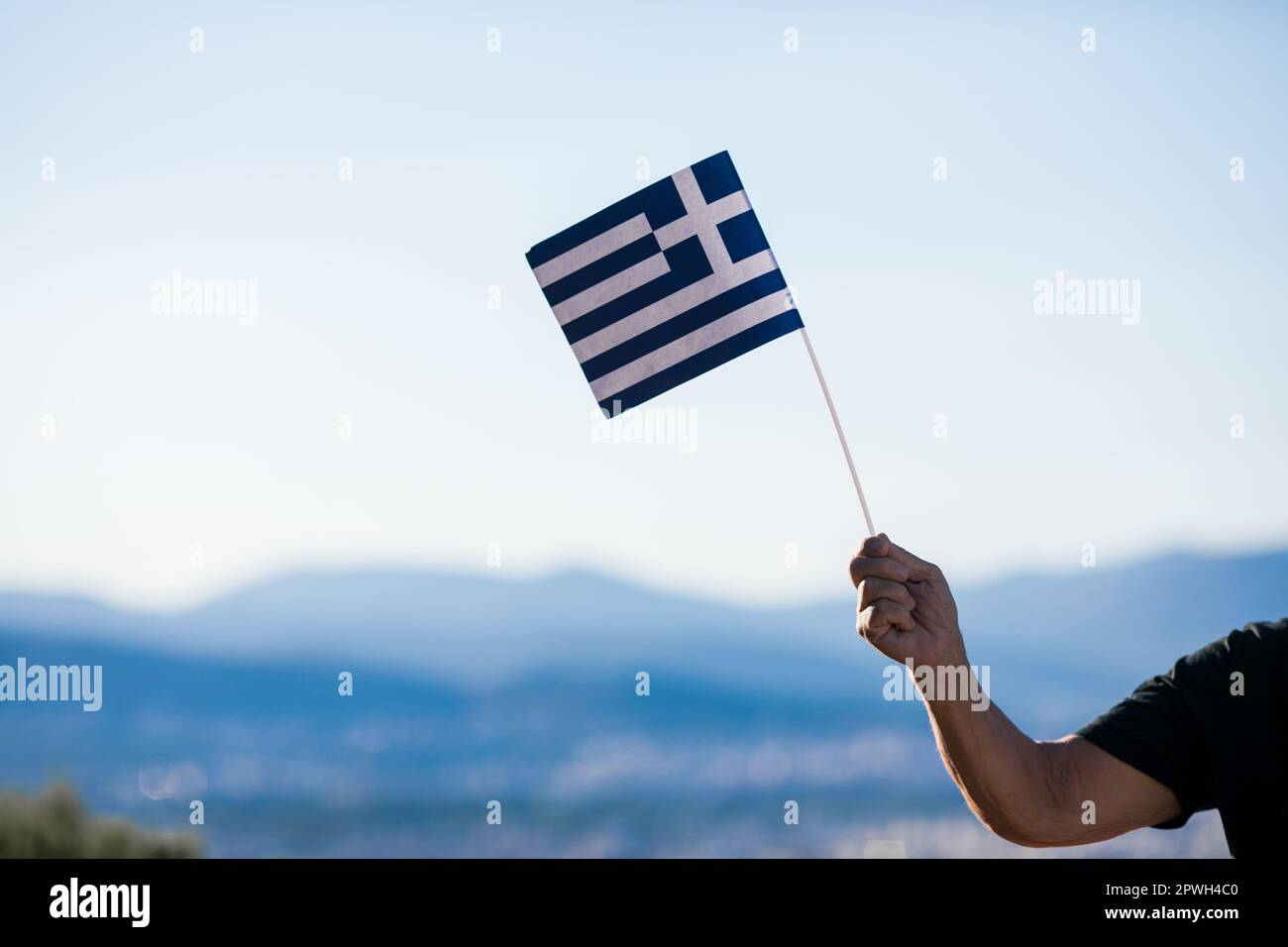 Handsome retired man with grey hair holding greece flag. national ...