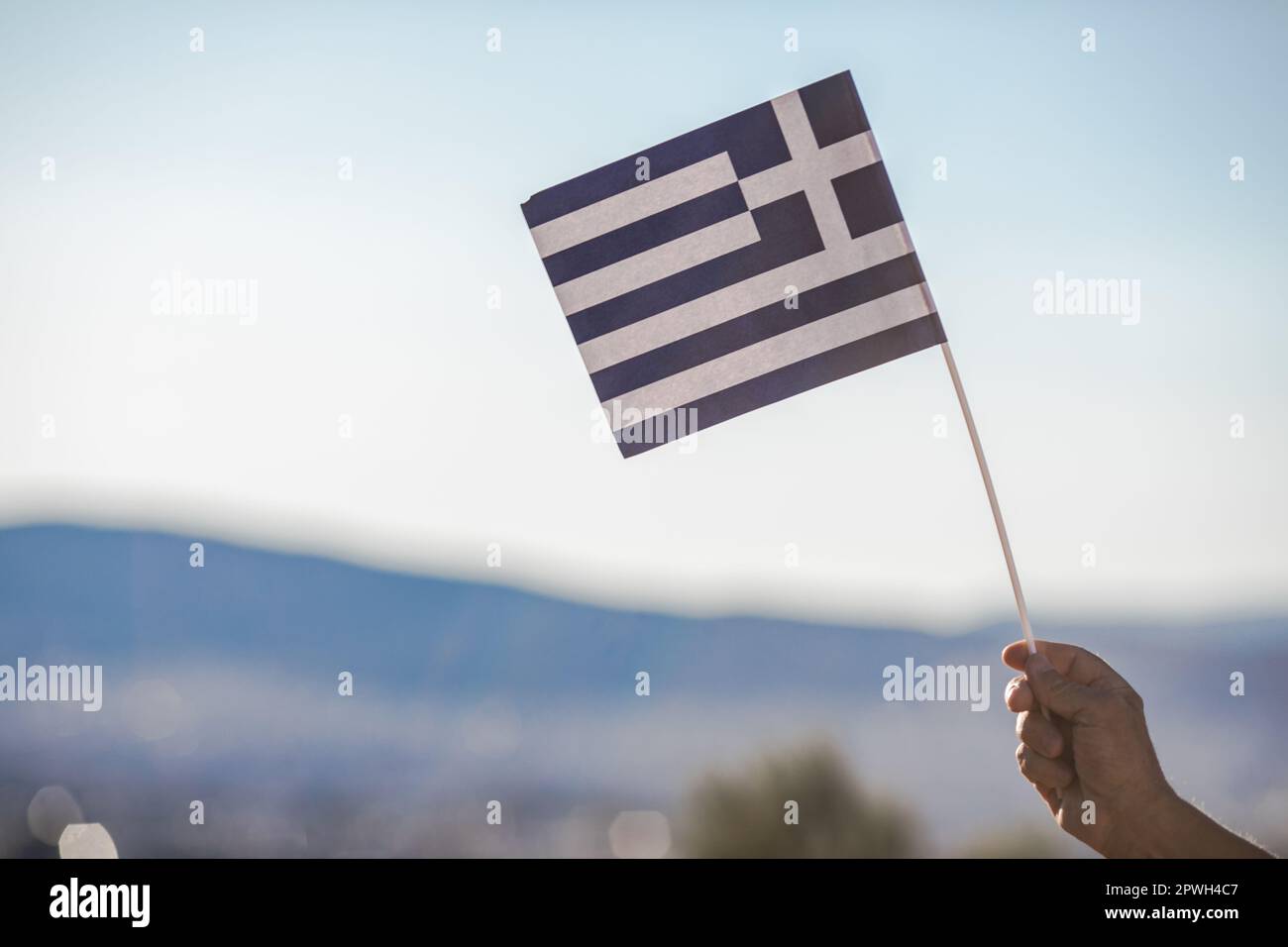 Handsome retired man with grey hair holding greece flag. national ...