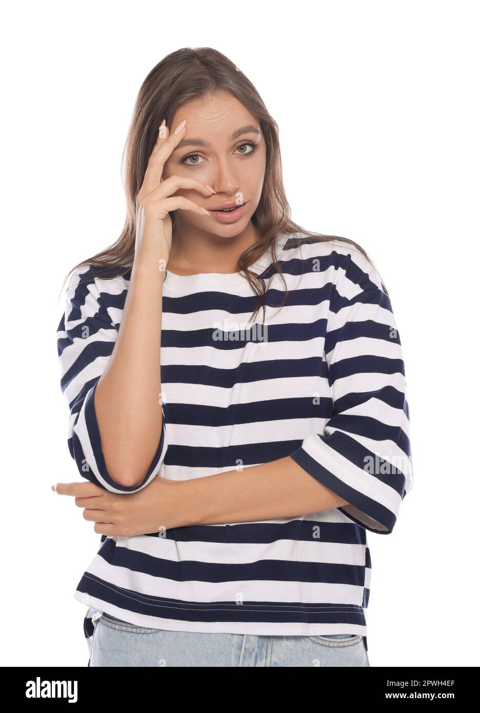Embarrassed woman covering face with hand on white background Stock ...