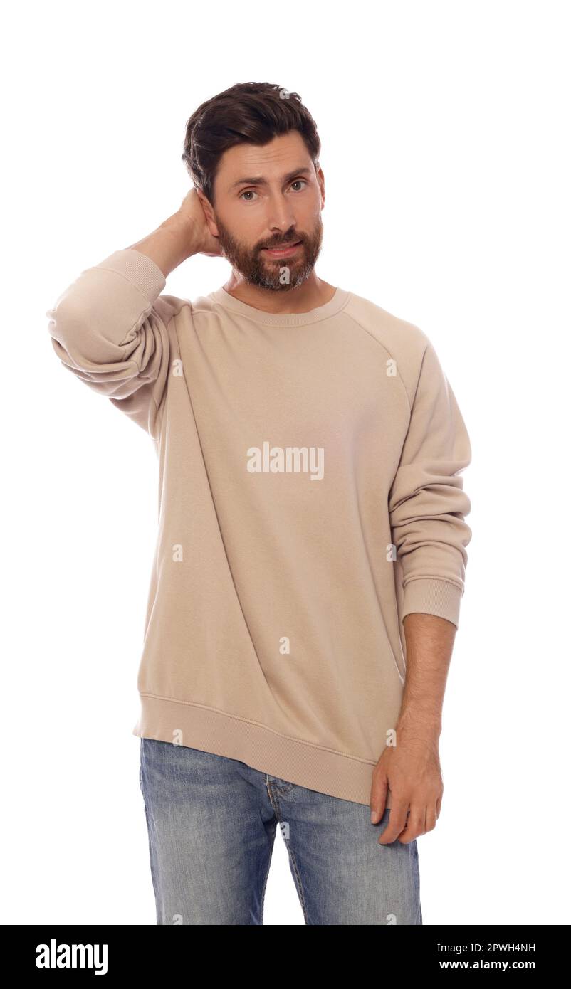 Embarrassed man in pullover on white background Stock Photo - Alamy